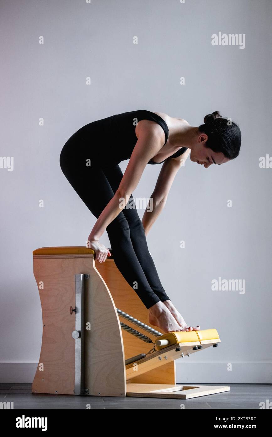 Pilates reformer chair woman fitness yoga gym exercise. Correction of ...
