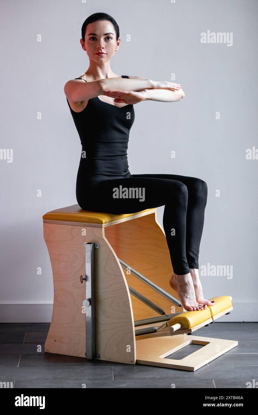 Pilates reformer chair woman fitness yoga gym exercise. Correction of ...