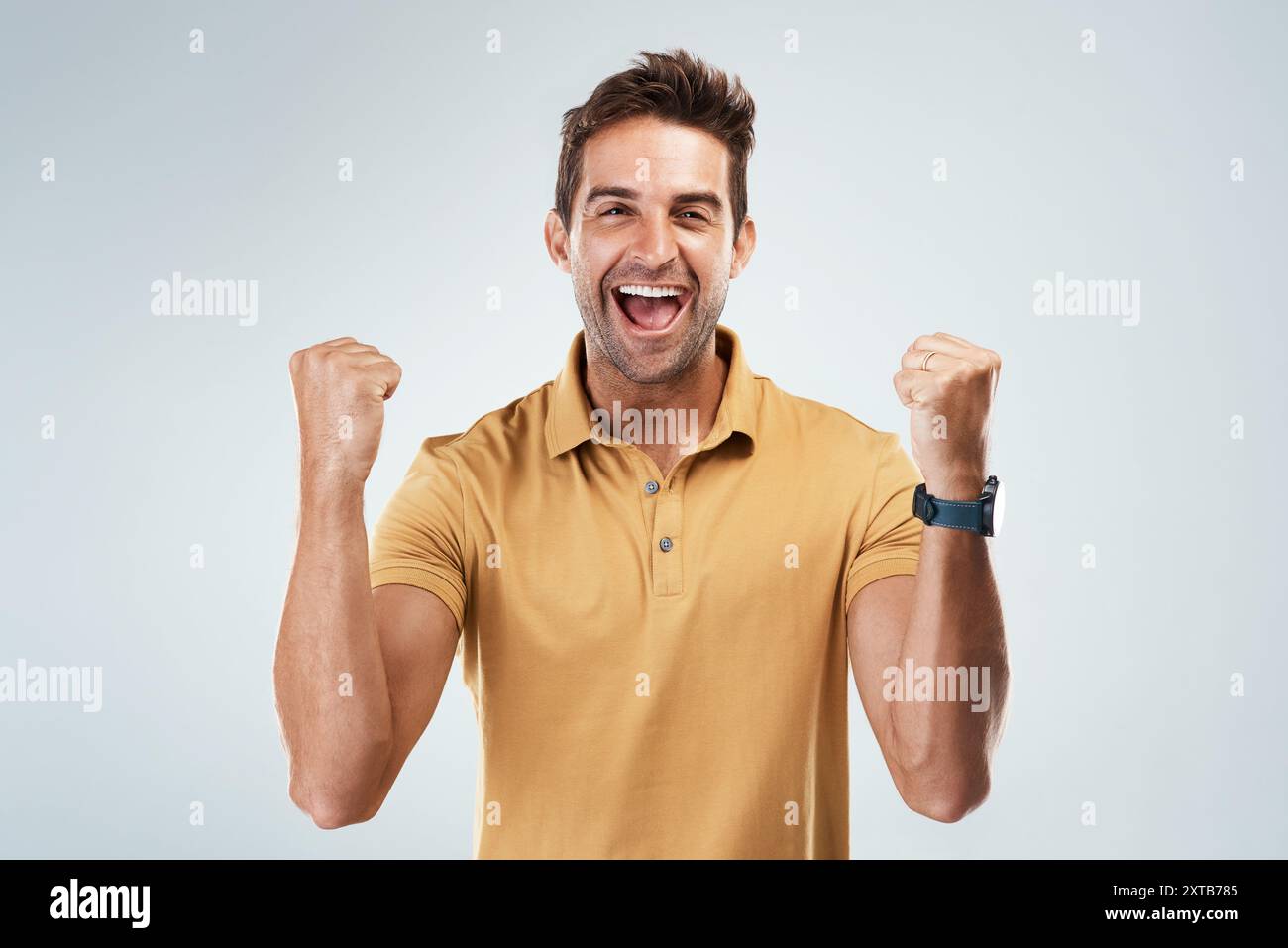 Fist pump, smile and winner with portrait of man in studio on white ...