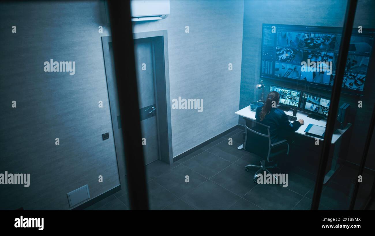 Female CCTV operator controls security cameras in monitoring center on ...