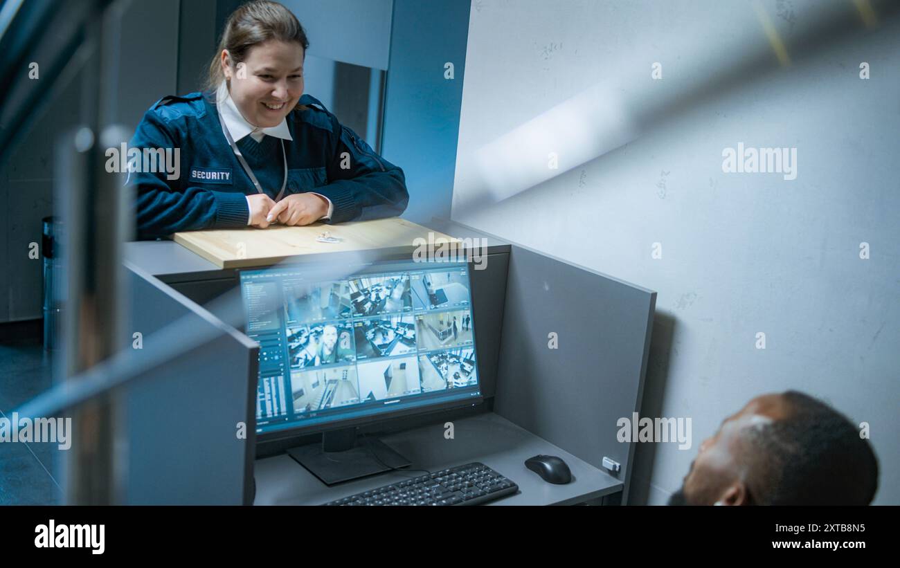 African American male security worker sits at workplace with computer ...