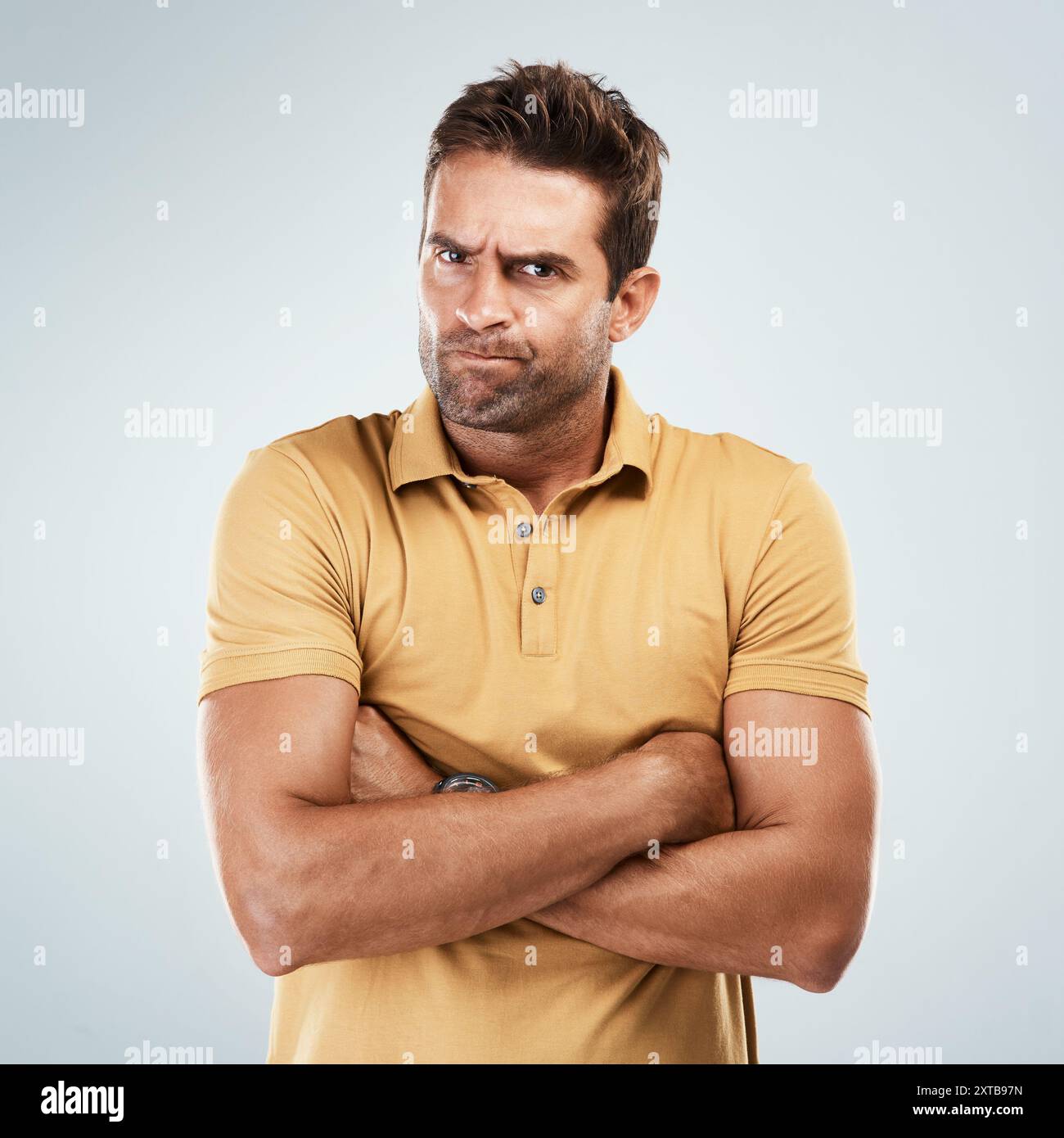 Man, angry and crossed arms in studio with white background for ...