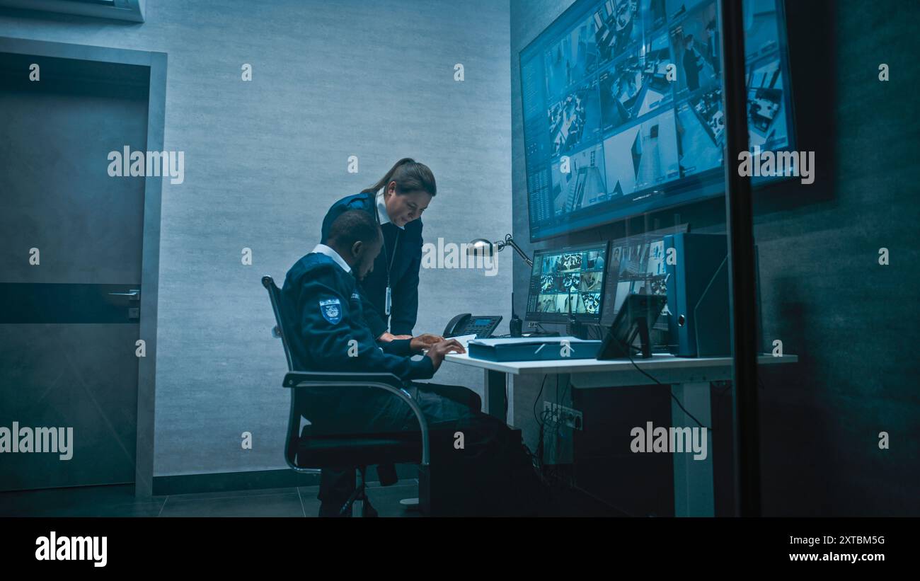 Female security worker have discussion with colleague in monitoring ...