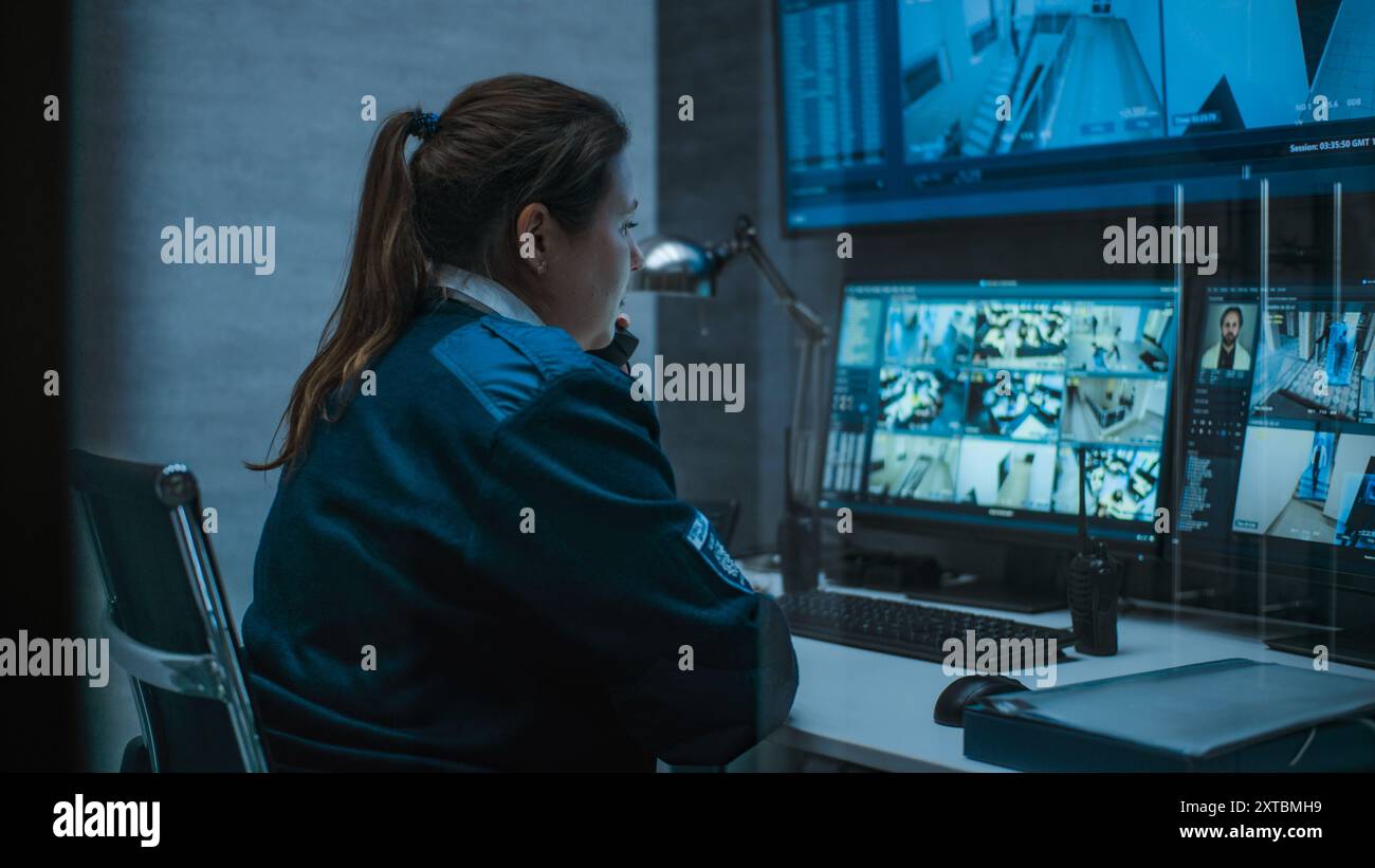 Female surveillance operator controls security cameras with face ...