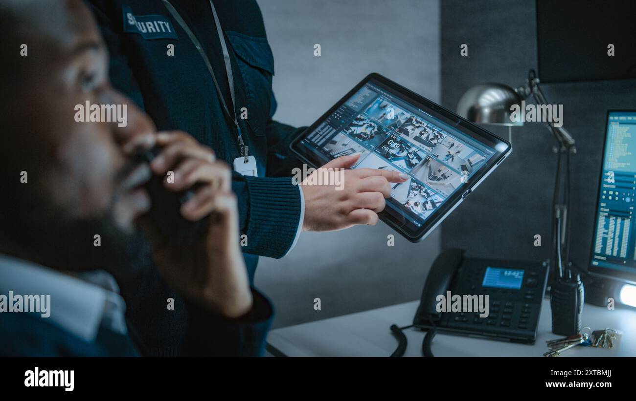 Female employee shows CCTV footage to African American male security ...