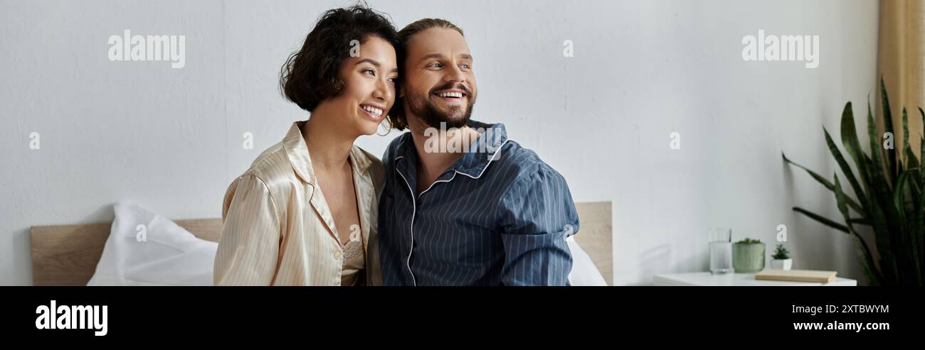 A loving couple in pajamas enjoys a quiet morning together, snuggling ...