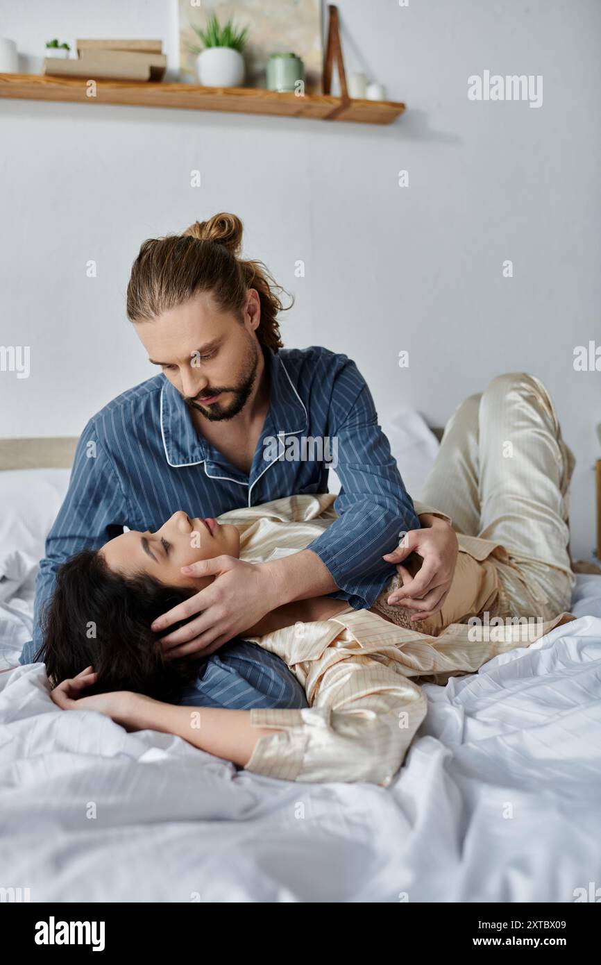 A couple shares a loving embrace in bed, a symbol of intimacy and ...
