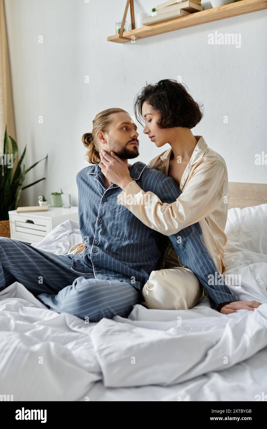 A loving couple shares a tender moment in bed, gazing into each others ...