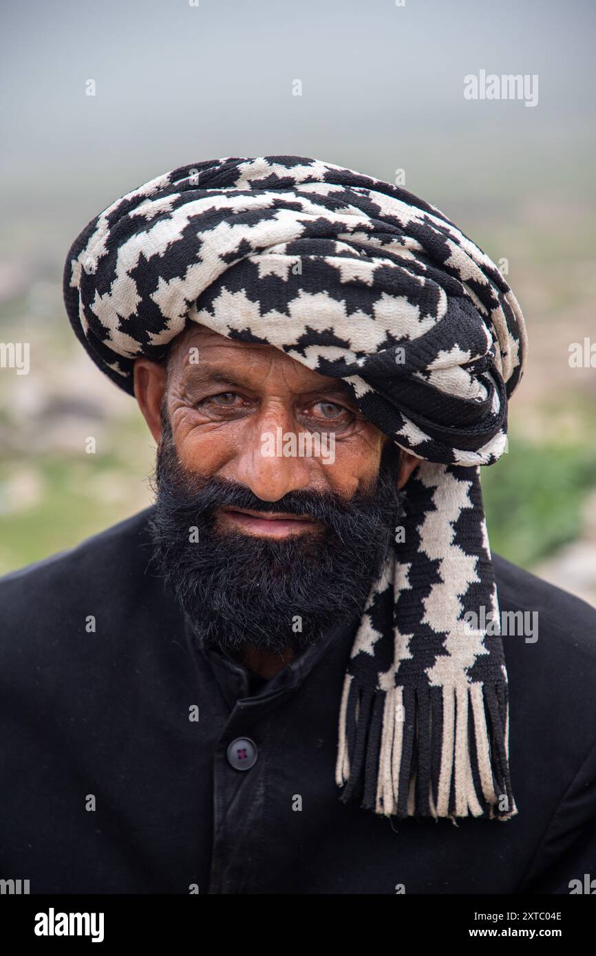 A nomadic man poses for a photo during a cloudy day near the Pir Panjal ...