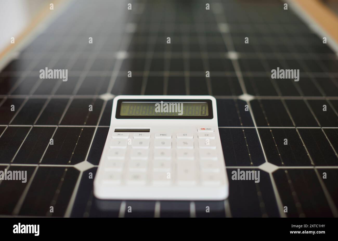 Calculator on photovoltaic solar panel illustrating concept of ...