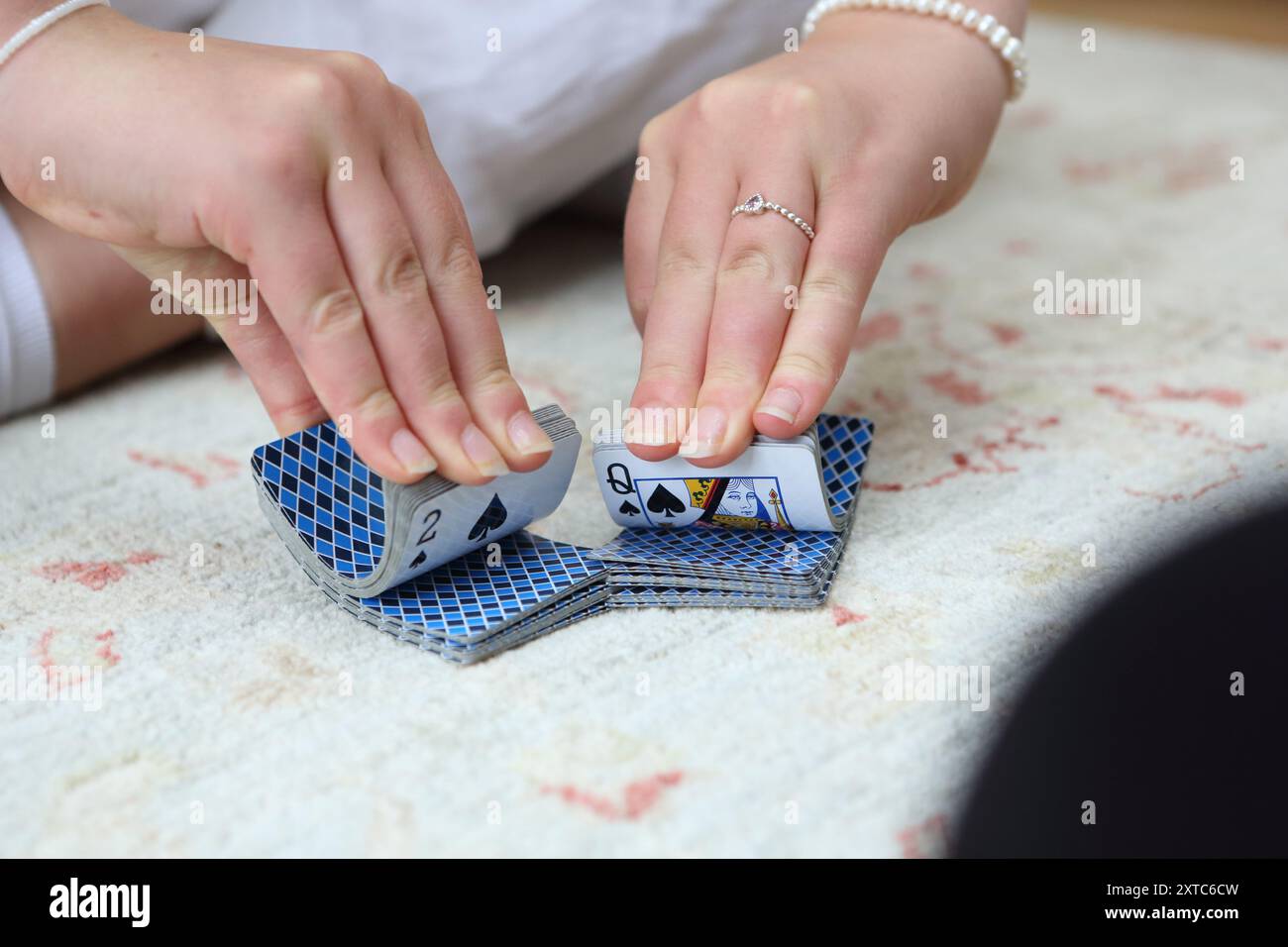Girl shuffling cards hi-res stock photography and images - Alamy