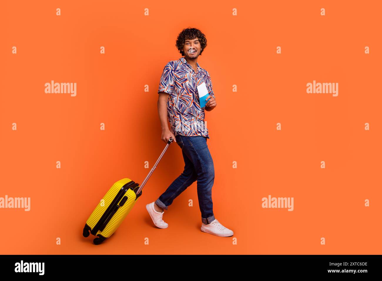 Full body photo of attractive young man walk travel hold tickets ...