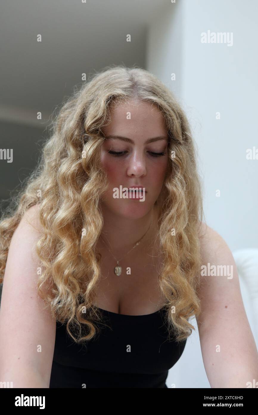 Teenage girl thinks about her next move in a card game - thinking turn ...