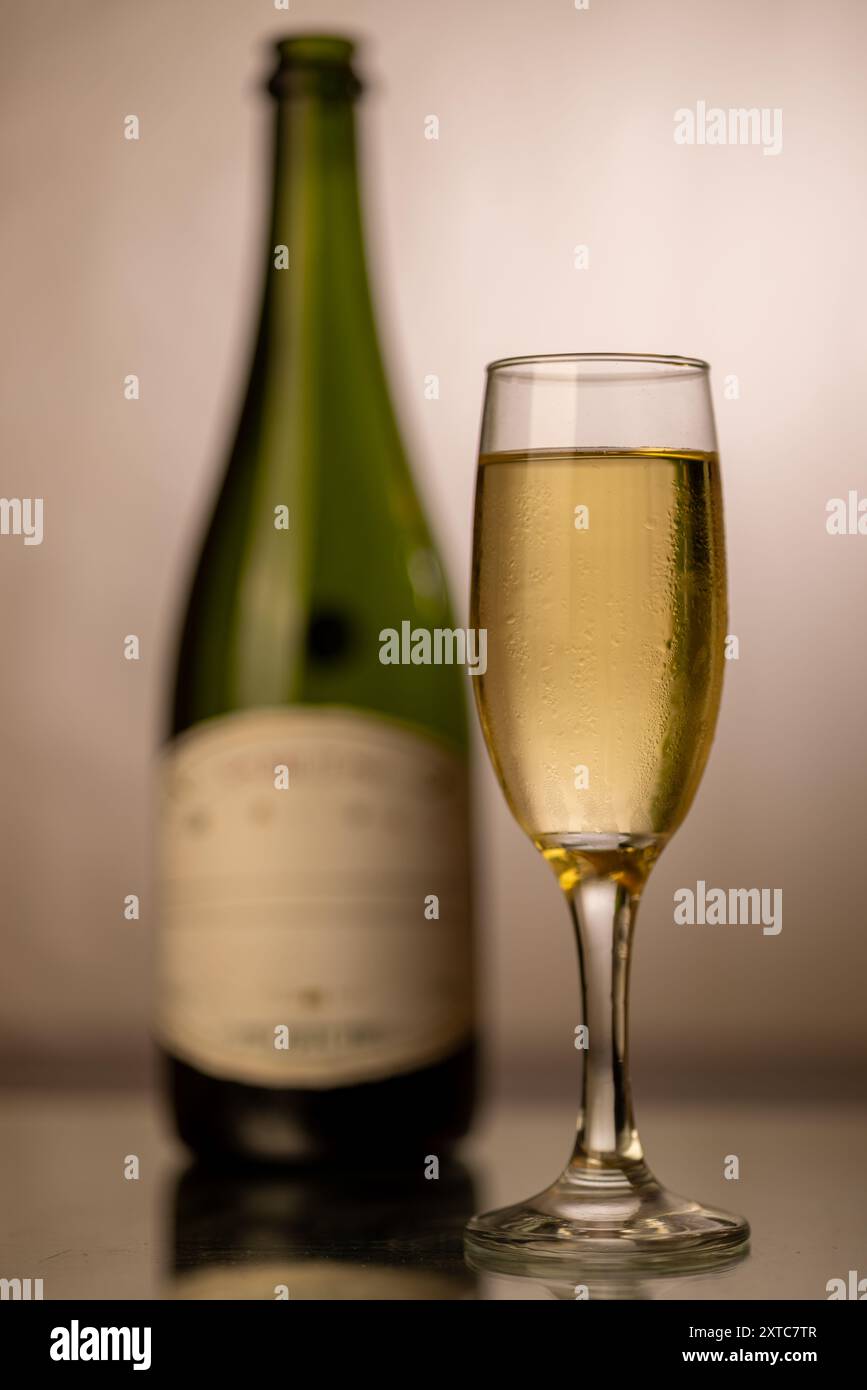A vertical image showcasing a close-up of a chilled champagne glass ...