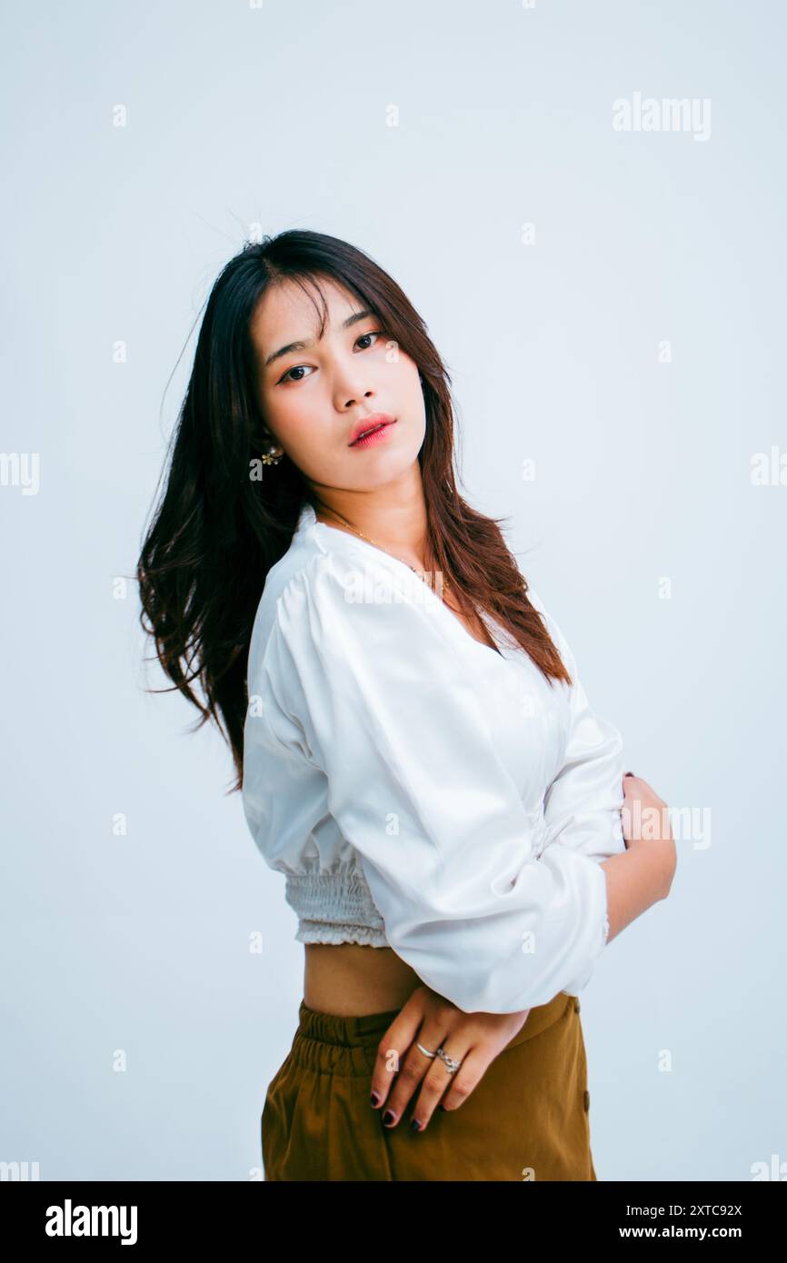 portrait of cold-faced half-body woman in white suit isolated on white ...