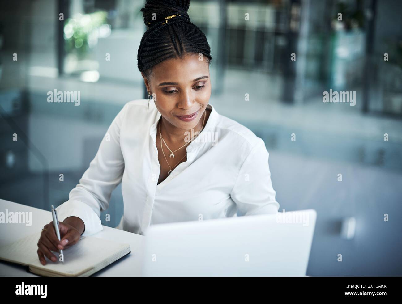 Black woman, laptop and notebook for planning in office, online ...