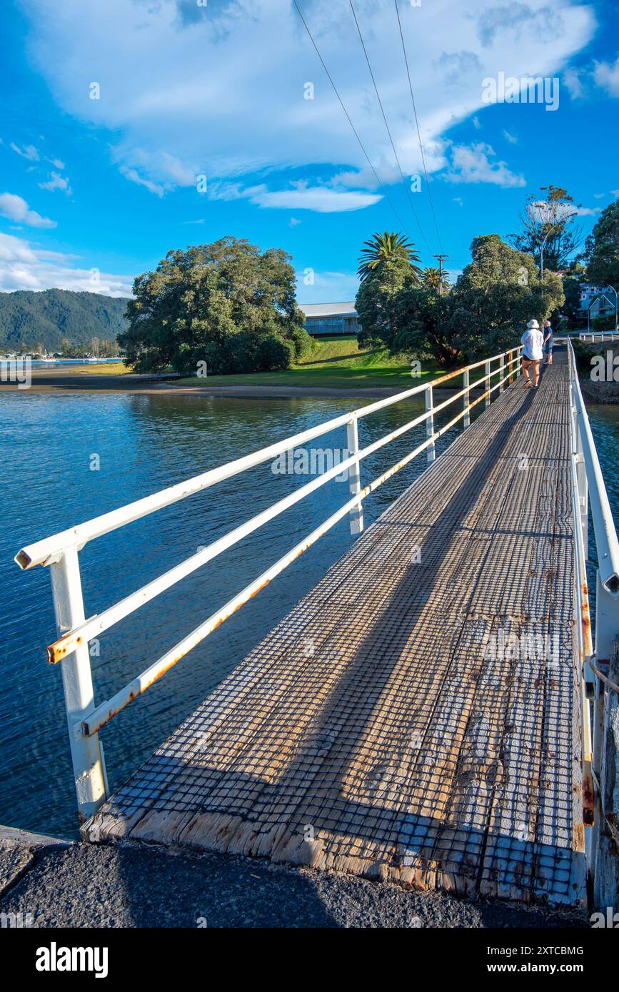 A footbridge that crosses a section of the Tairua River alongside the ...