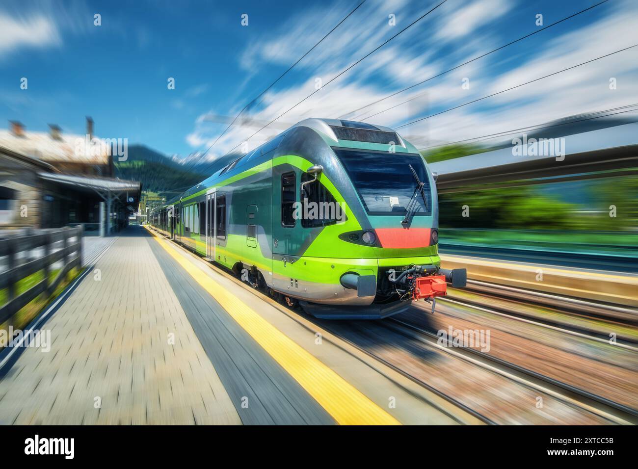 High-speed passenger train moving at railway station platform Stock ...