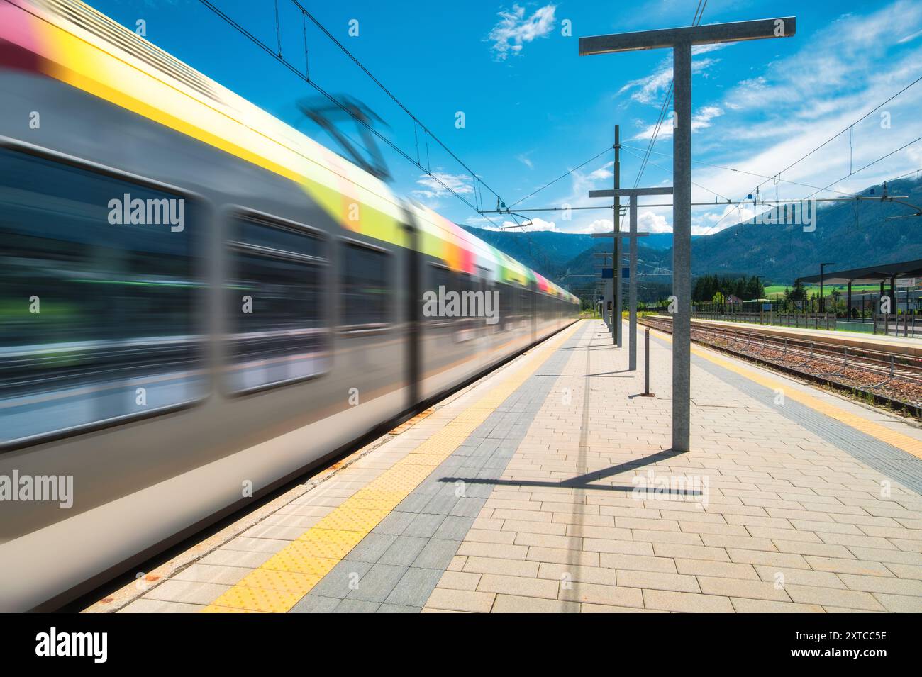 High-speed passenger train moving at railway station platform Stock ...