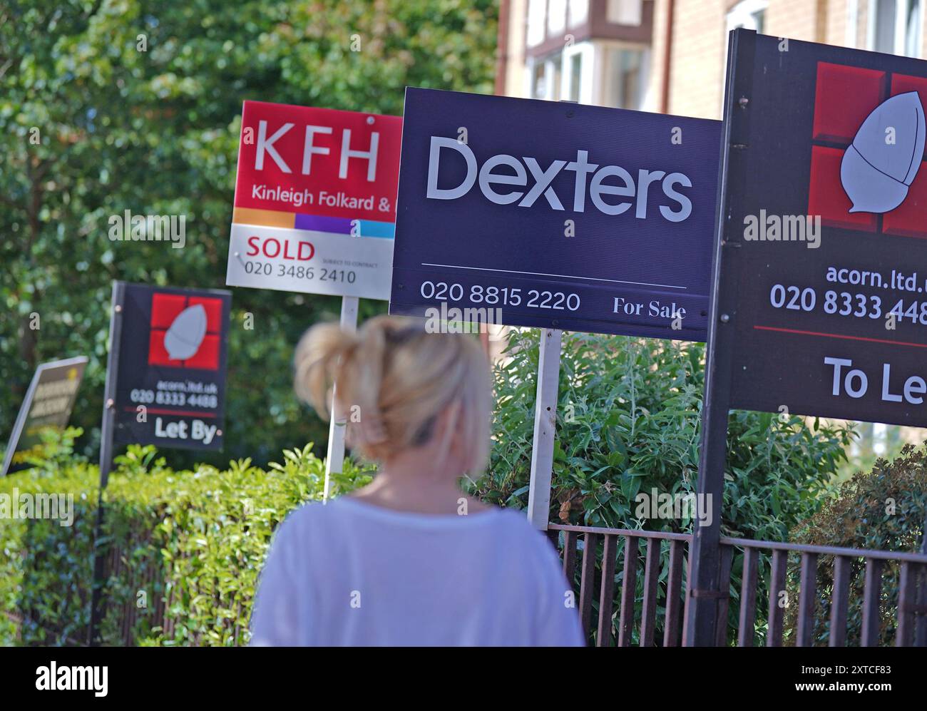 File photo dated 17/08/23 of estate agent signs outside apartments in ...