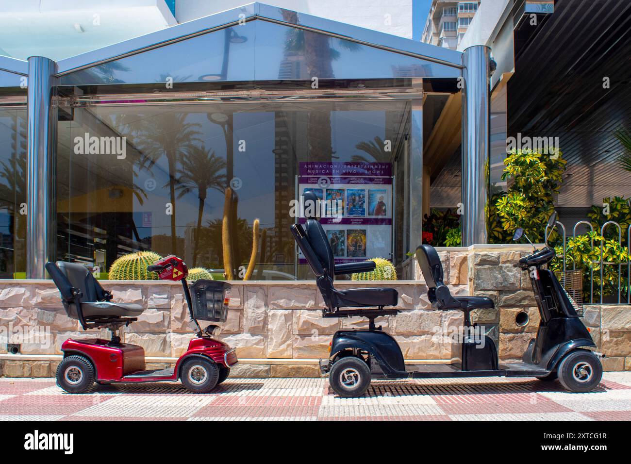 Electric vehicles, electric mobility scooters in front of a hotel in ...