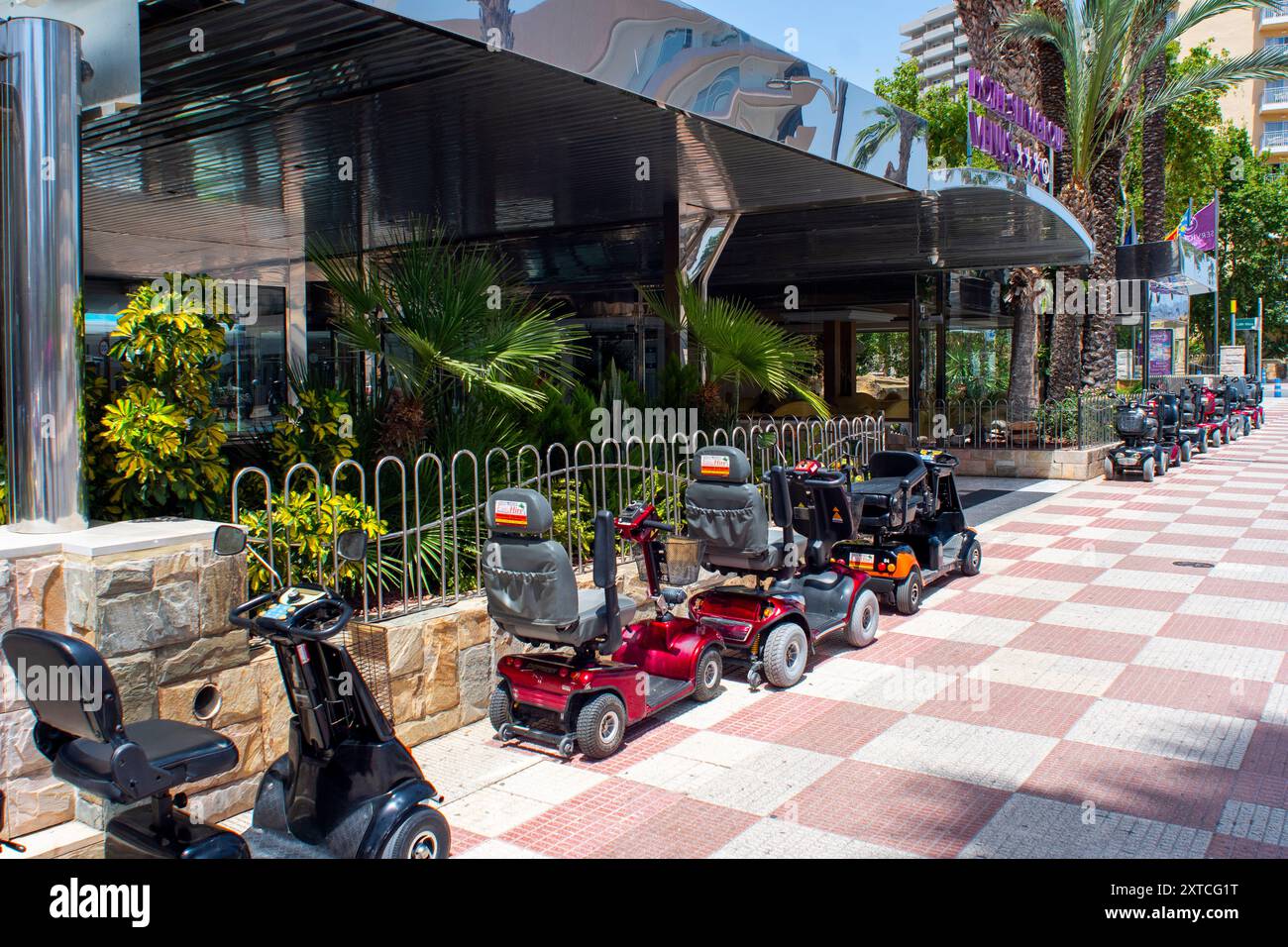 Electric vehicles, electric mobility scooters in front of a hotel in ...