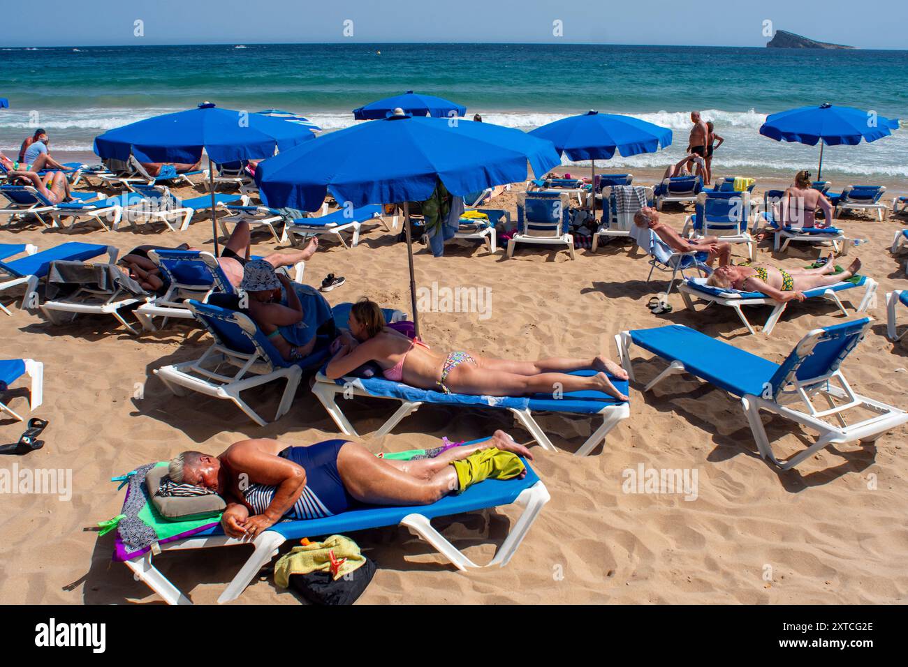Holidaymakers bask in the sun on Levante Beach in Benidorm, Alicante ...