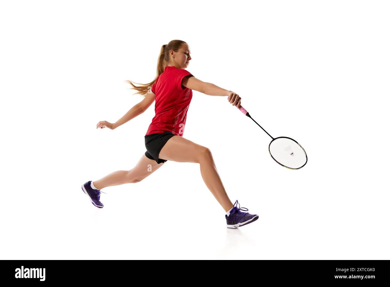 Young woman, badminton athlete leaping in motion, ready to hit ...