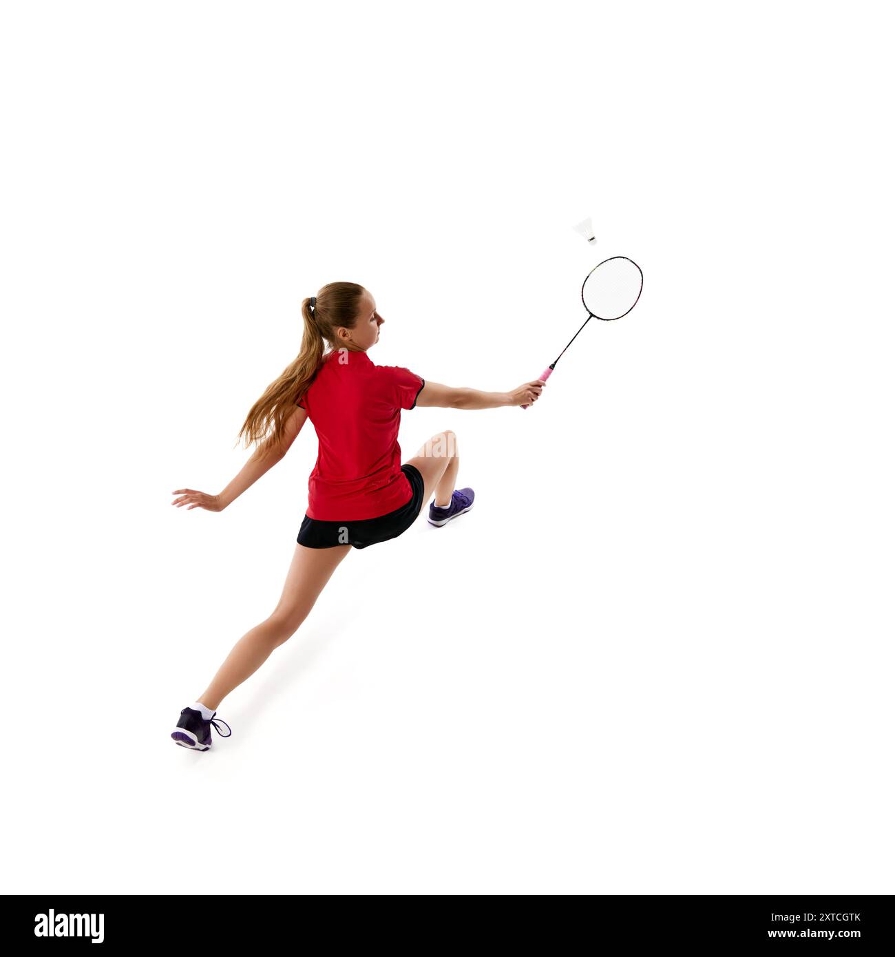 High angle view of young woman, badminton player hit shuttlecock ...