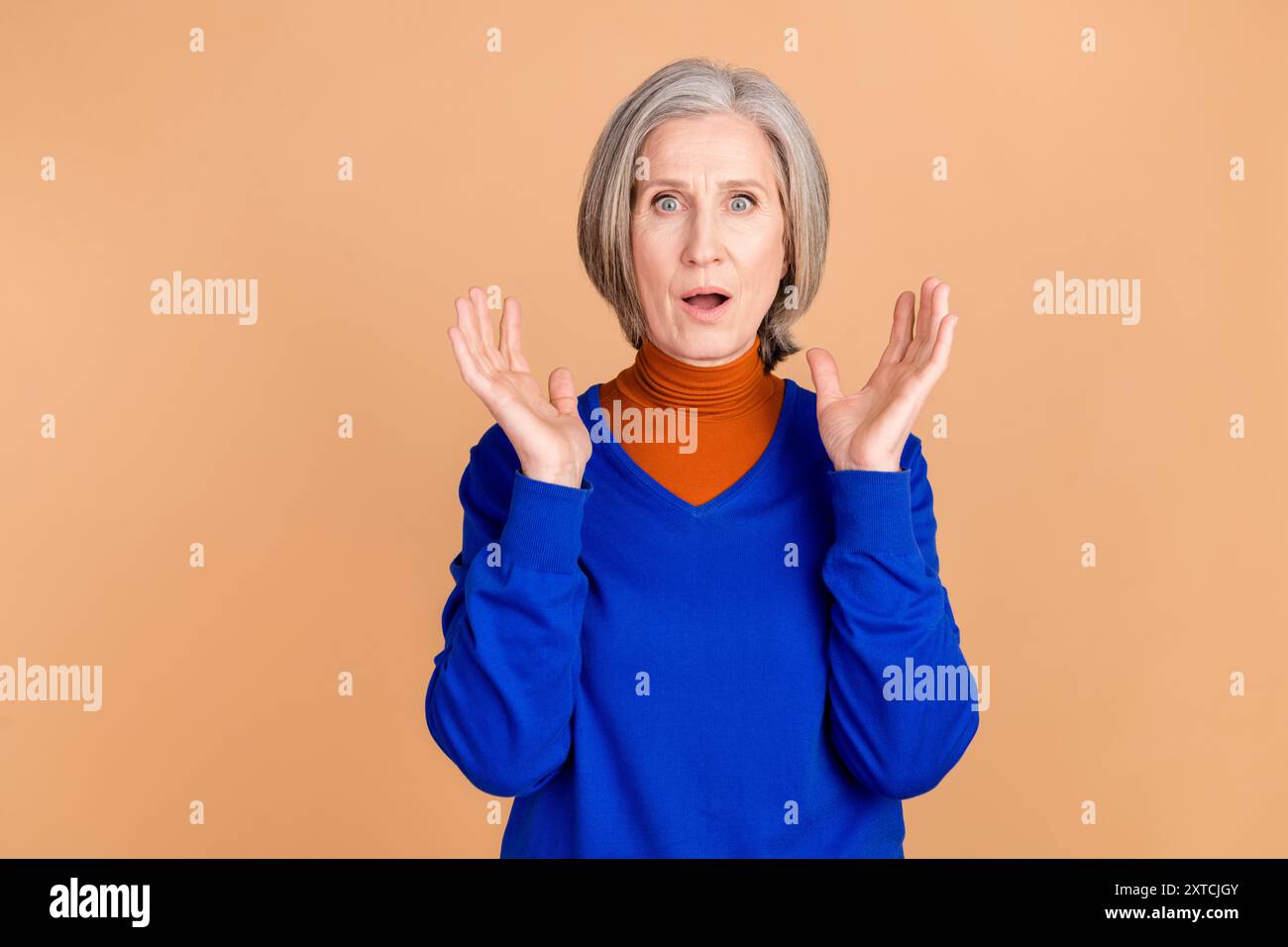 Photo portrait of nice senior woman scared raise hands wear trendy blue ...
