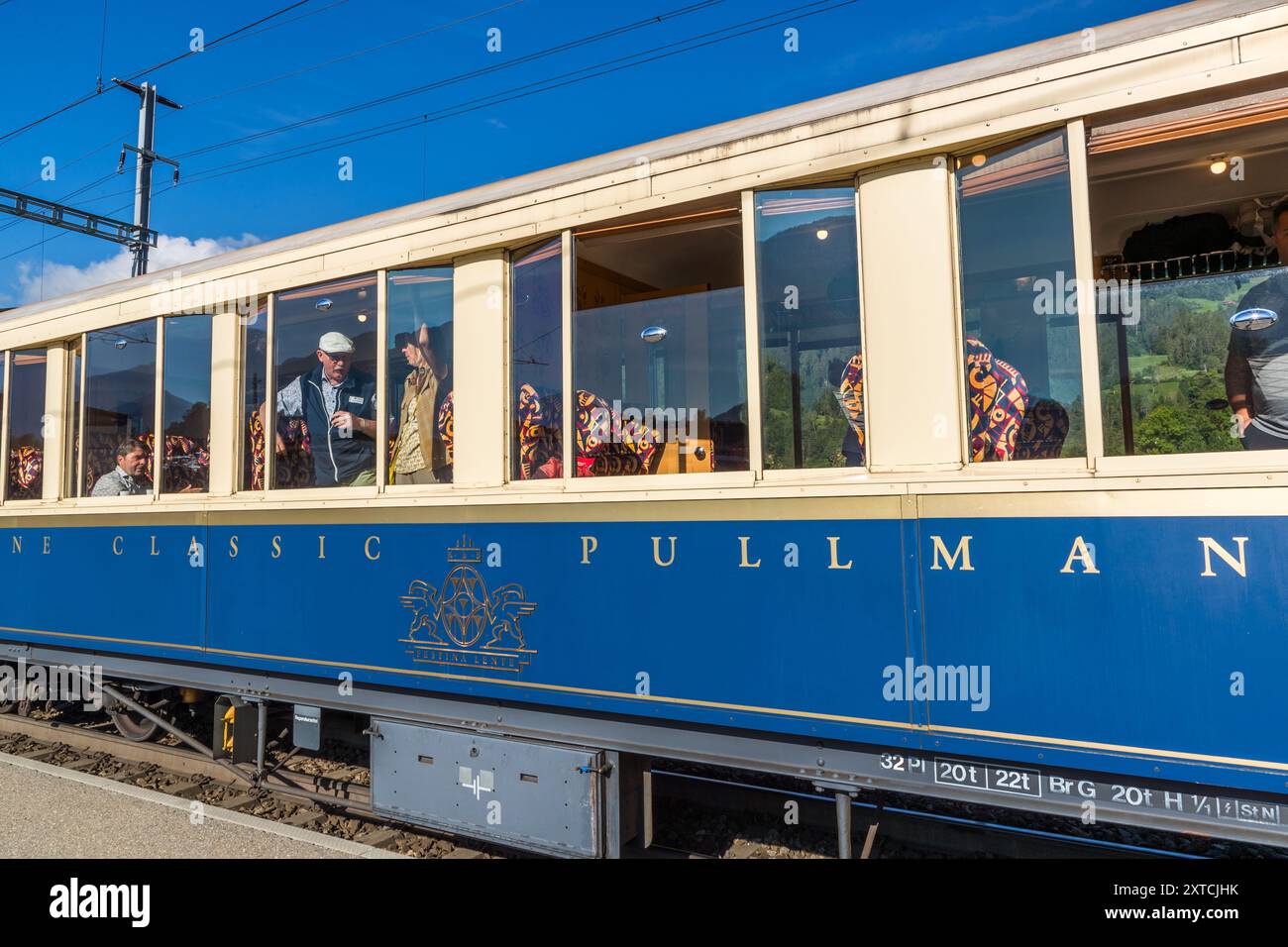 Blue and white Alpine Classic Pullman Express wagon with passengers on ...