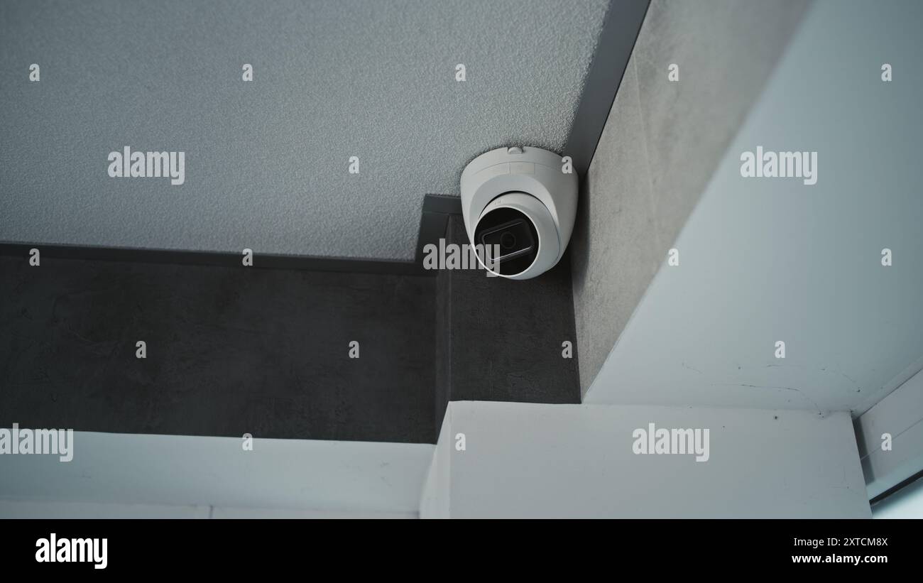 Close up shot of installed CCTV camera hanging on the ceiling in the ...