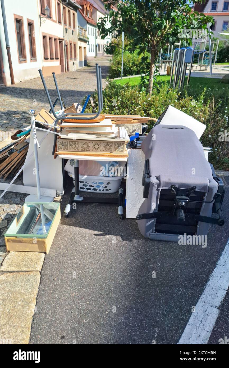 Discarded items including overturned office chair, wooden boards, home ...