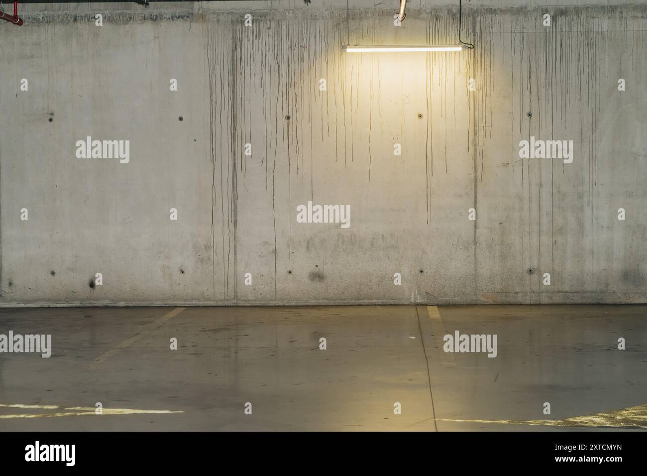 Parking lot with overhead dim light, underground parking garage Stock ...