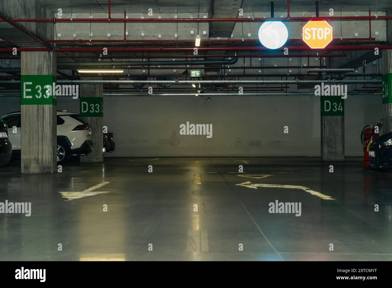 Parking lot with overhead dim light, underground parking garage Stock ...