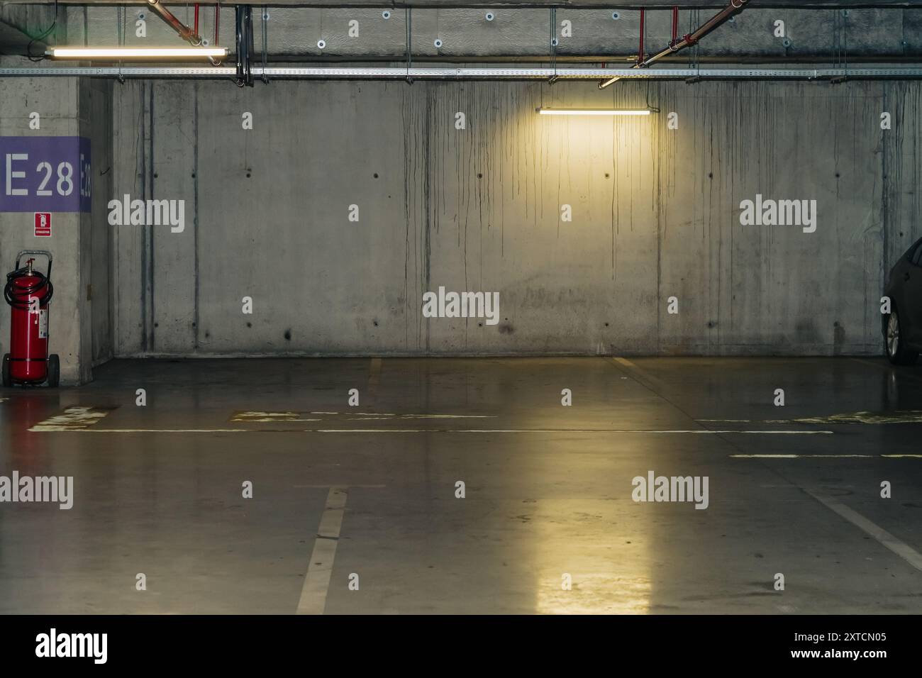 Parking lot with overhead dim light, underground parking garage Stock ...