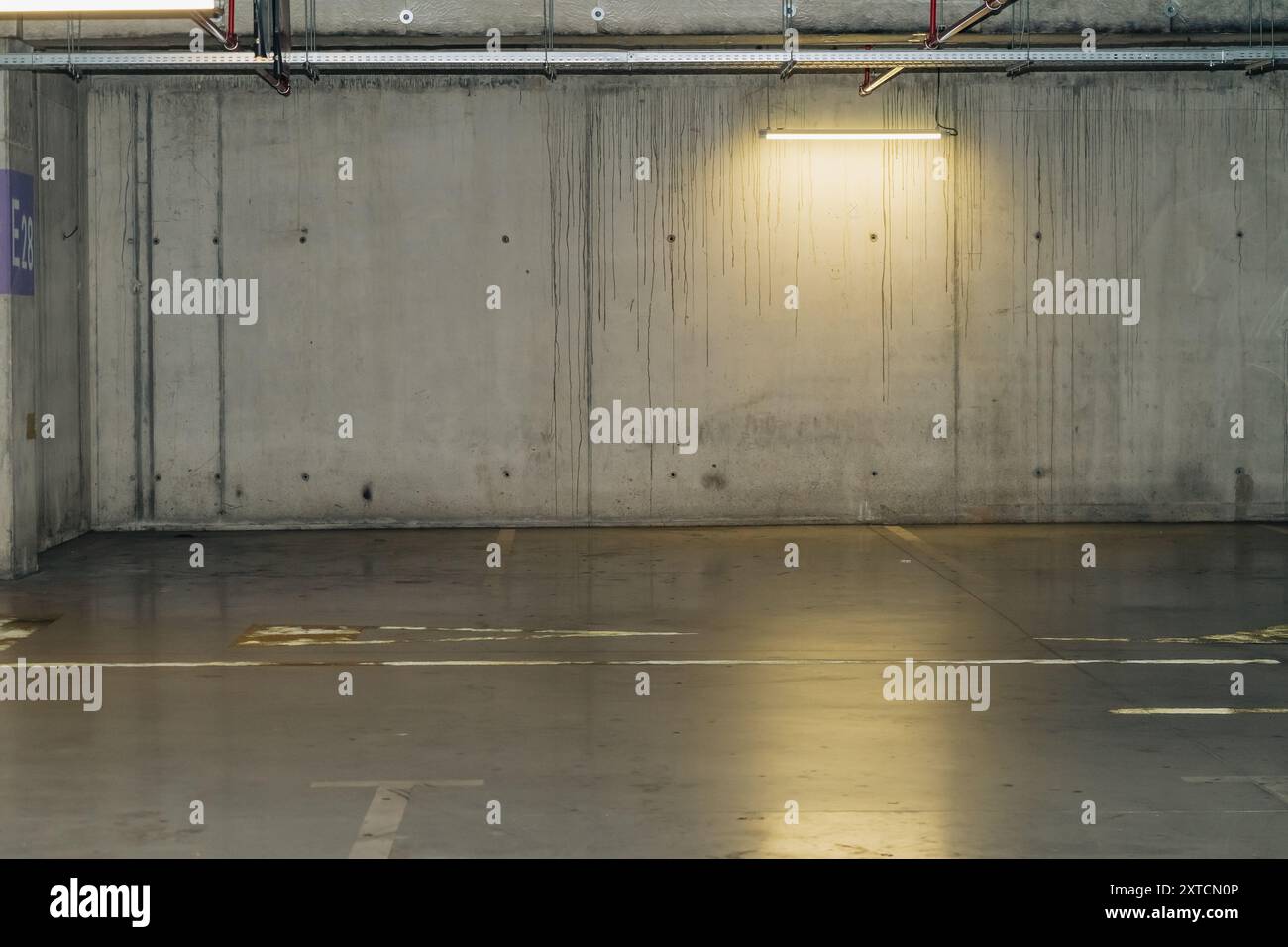 Parking lot with overhead dim light, underground parking garage Stock ...
