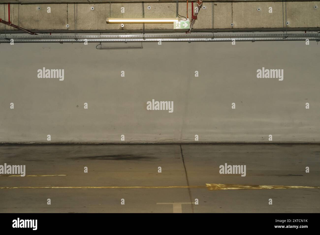 Parking lot with overhead dim light, underground parking garage Stock ...