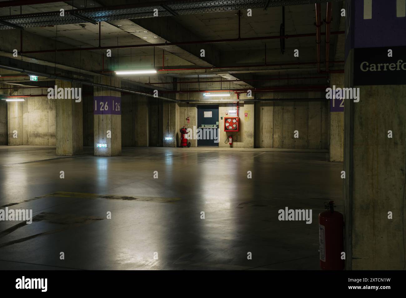 Parking lot with overhead dim light, underground parking garage Stock ...