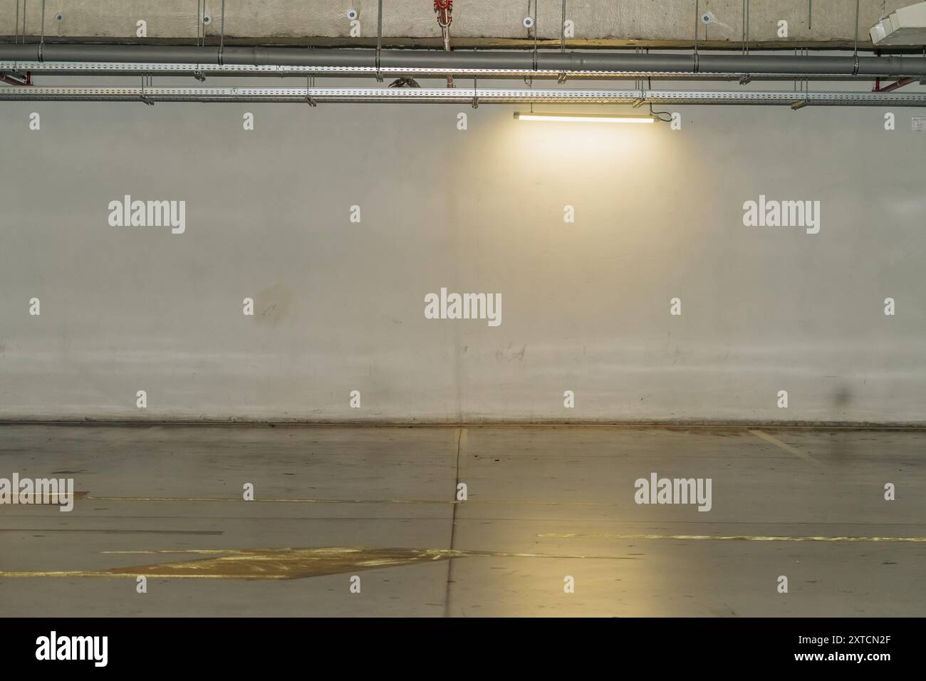 Parking lot with overhead dim light, underground parking garage Stock ...
