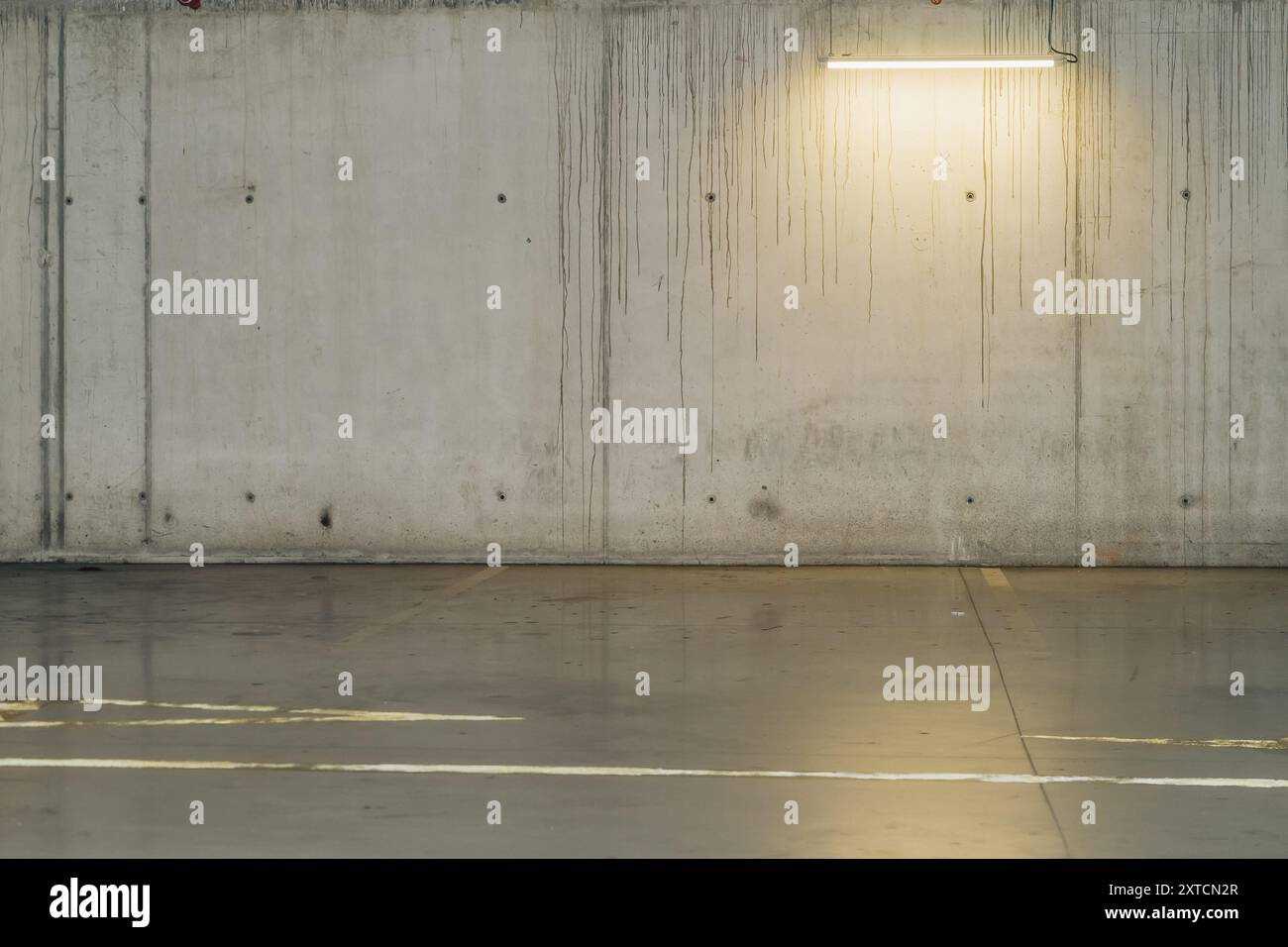 Parking lot with overhead dim light, underground parking garage Stock ...