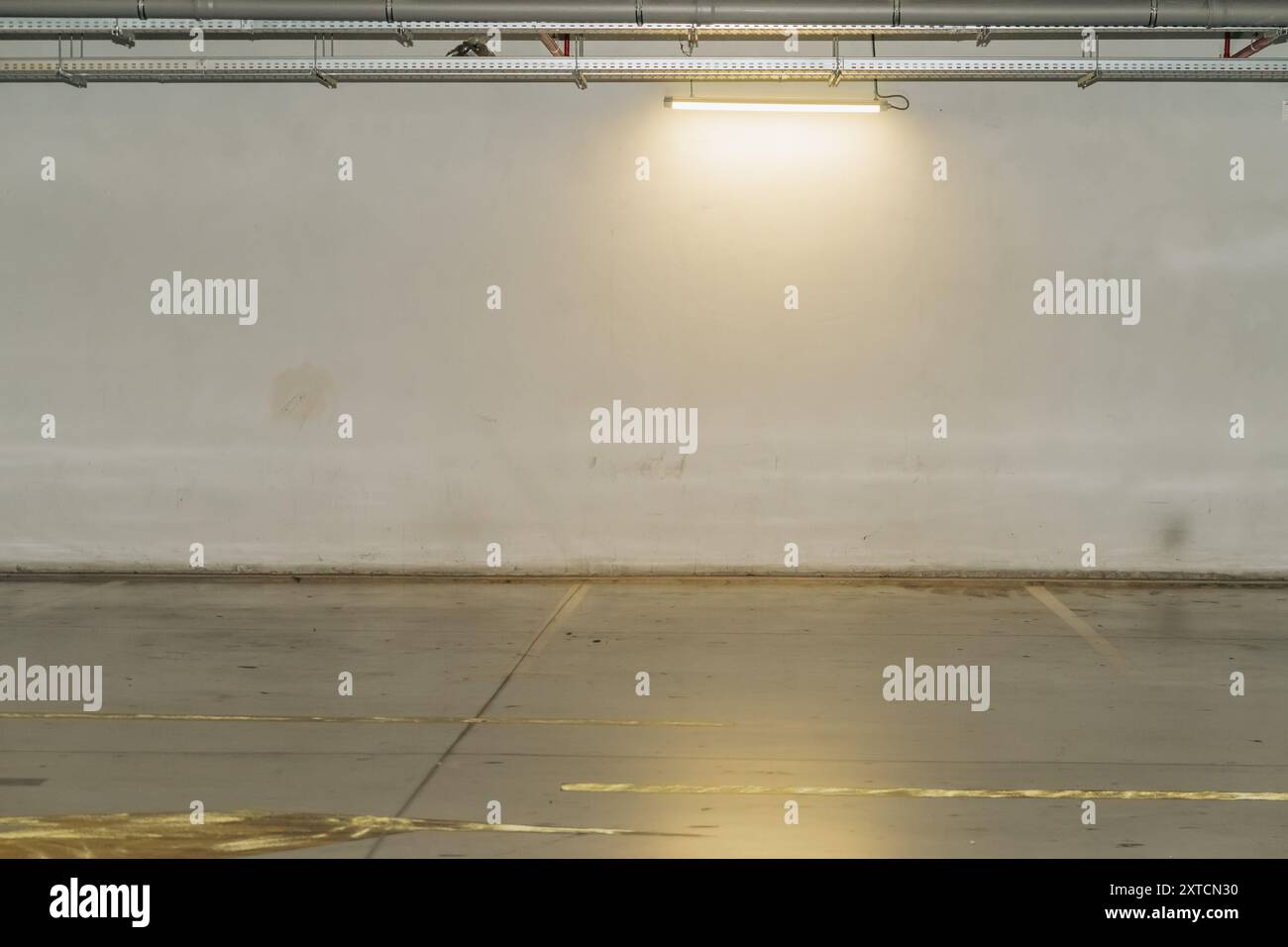Parking lot with overhead dim light, underground parking garage Stock ...