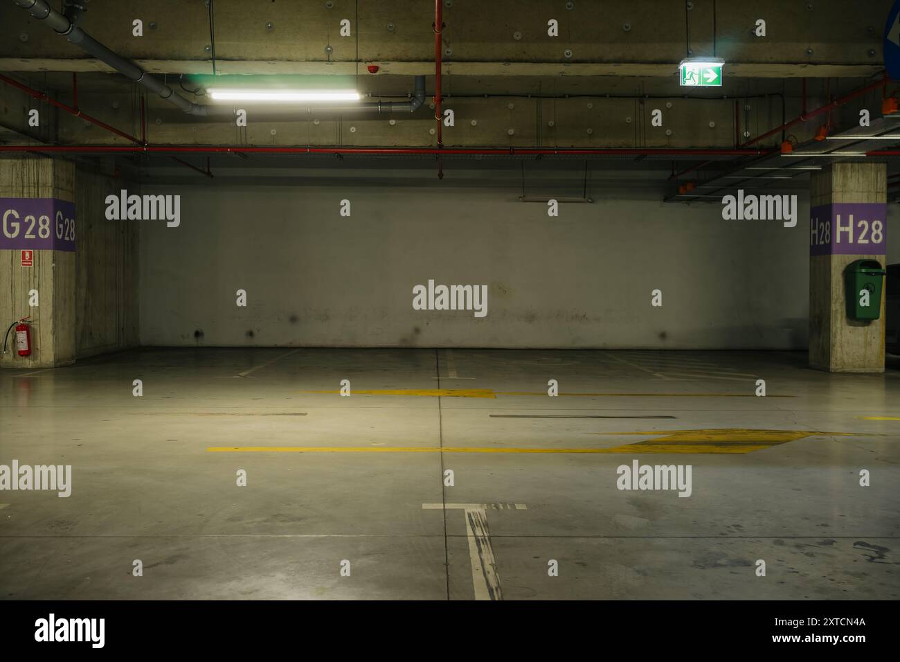 Parking lot with overhead dim light, underground parking garage Stock ...