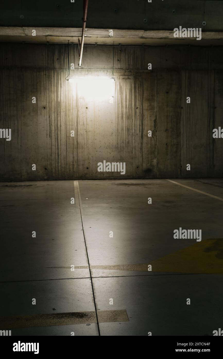 Parking lot with overhead dim light, underground parking garage Stock ...
