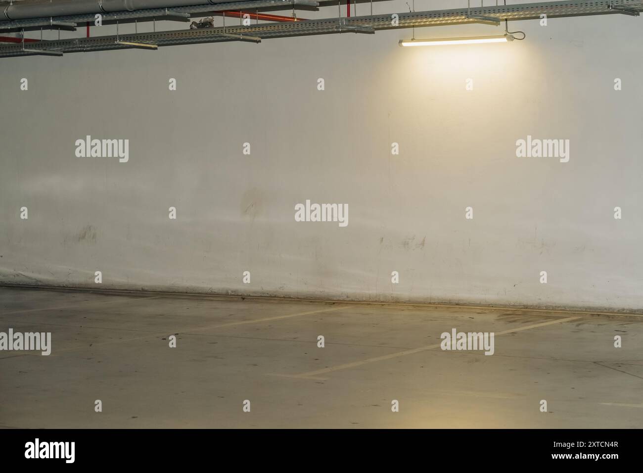 Parking lot with overhead dim light, underground parking garage Stock ...