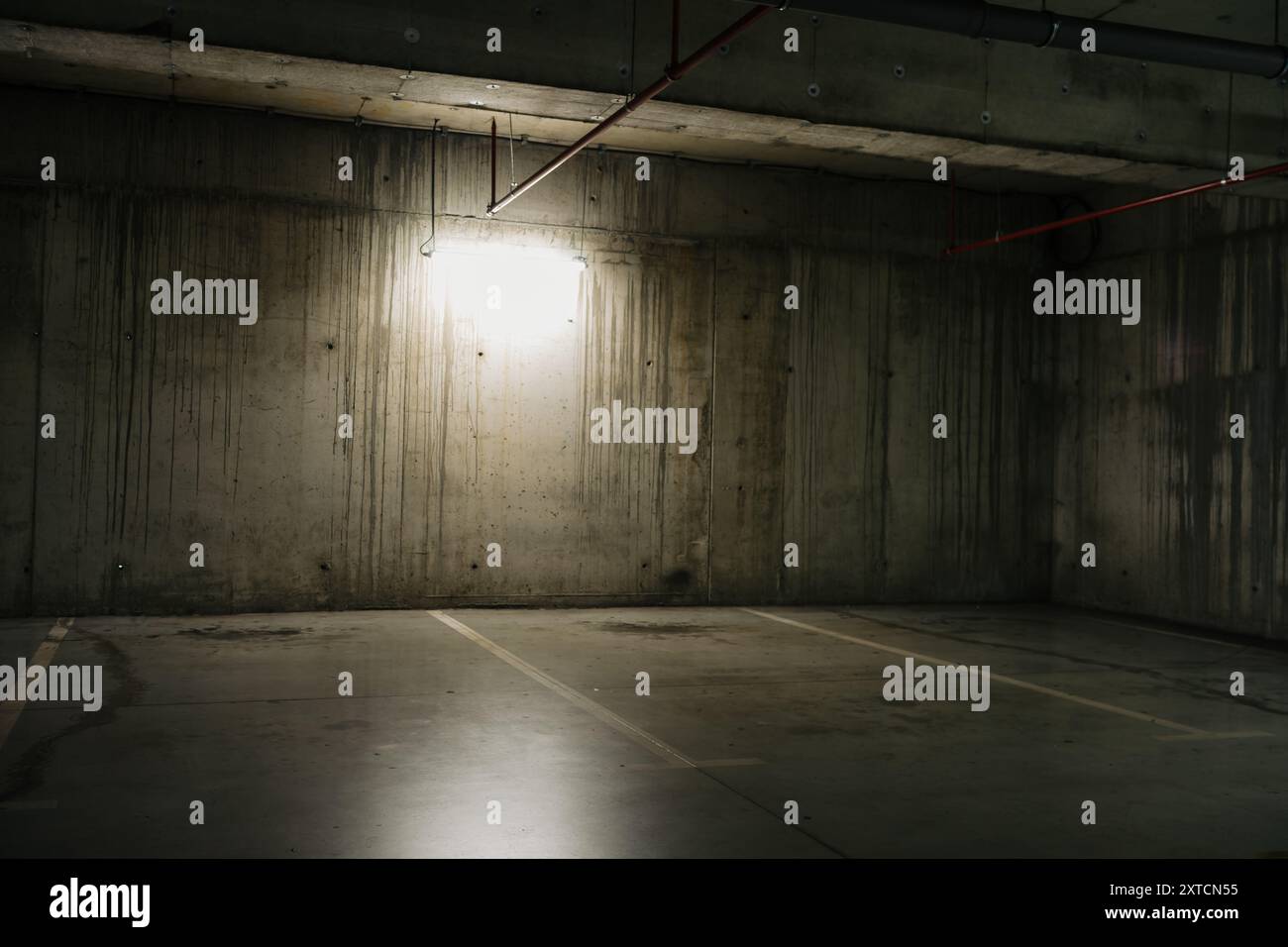 Parking lot with overhead dim light, underground parking garage Stock ...