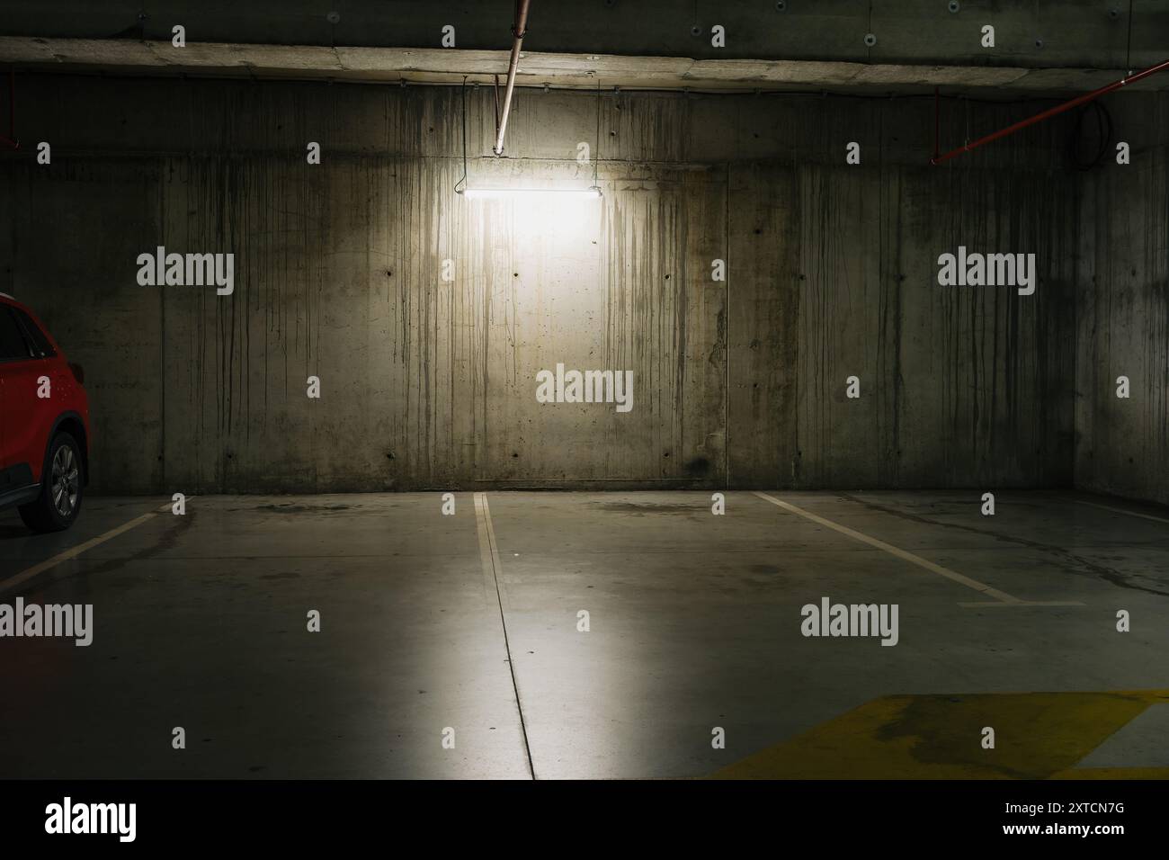 Parking lot with overhead dim light, underground parking garage Stock ...