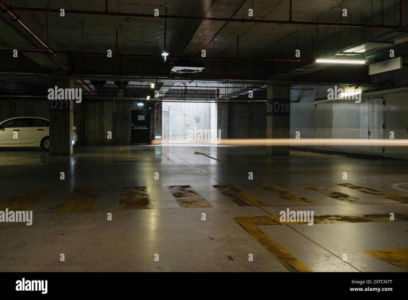 Parking lot with overhead dim light, underground parking garage Stock ...