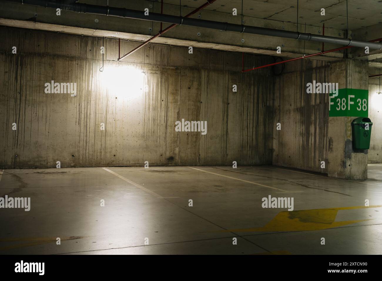 Parking lot with overhead dim light, underground parking garage Stock ...