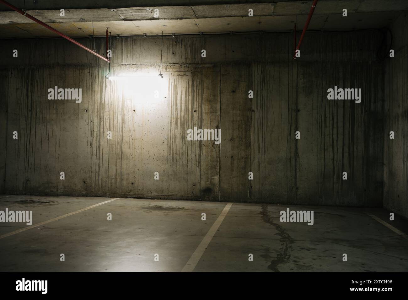 Parking lot with overhead dim light, underground parking garage Stock ...